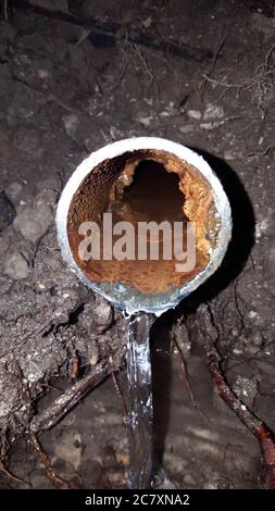Broken Pipe Underground with Running Water Pouring Out Stock Photo - Alamy