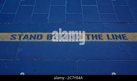 Caution, stand behind the yellow line sign in a Vancouver Skytrain ...