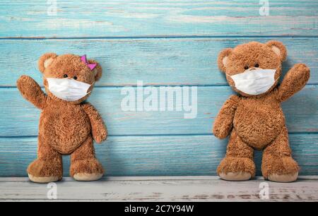 Woman in a face mask behind cafe counter with safety screen, offering a ...