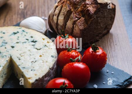 Closeup shot of blue cheese surrounded by tomatoes Stock Photo - Alamy