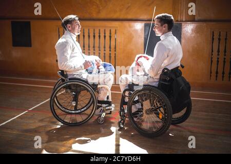 two disabled fencer's masks look at each other Stock Photo - Alamy