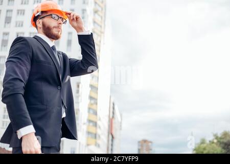 Engineer builder wearing suit and helmet at construction site Stock ...