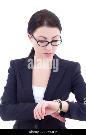 Portrait of corporate woman checks her time, stands on street outside ...