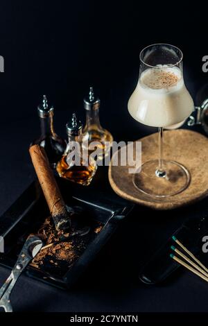 colorful cocktail with a cigar on a beautiful composition with drops ...