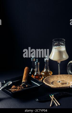 colorful cocktail with a cigar on a beautiful composition with drops ...