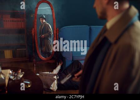 Male detective with gun standing at the mirror, crime scene, retro ...