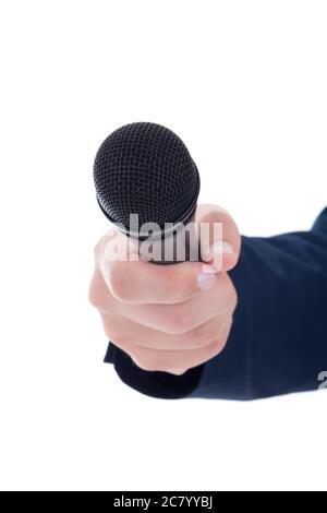 Journalist's hand with microphone on grey background Stock Photo - Alamy