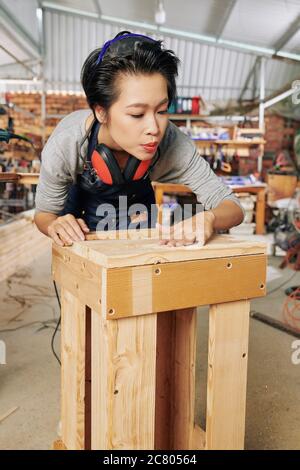 young asian female assembling furniture on her own Stock Photo - Alamy