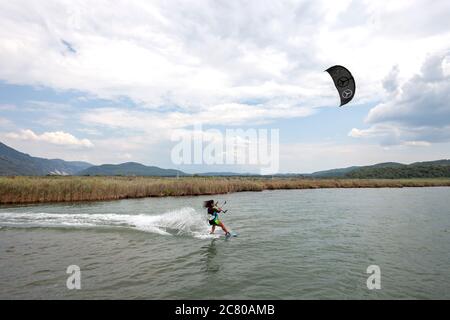 Young Woman Kiteboarding on the sea in Summer Day Stock Photo - Alamy