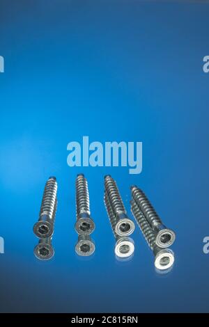 Countersunk wood screws on a blue background Stock Photo - Alamy