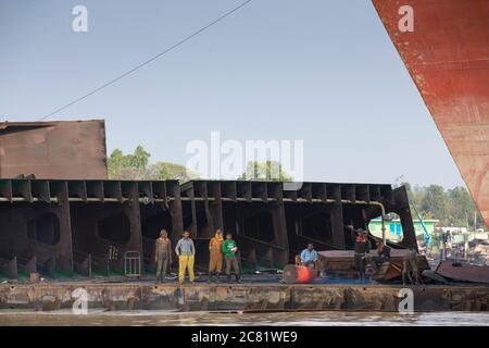 Bangladesh ship breaking yard (Chittagong). Ship recycling yard with industrial workers, heavy ...