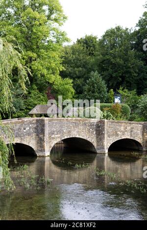 Cotswolds village of Bibury Arched Bridge over the River Coln in Bibury ...