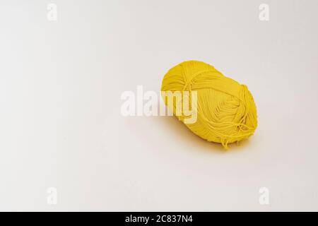 a single simple colorful knitting yarn roll float in the air, isolated ...