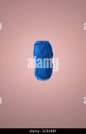 single simple colorful knitting yarn roll float in the air, isolated ...