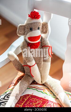 Closeup shot of a toy monkey on pink background Stock Photo - Alamy