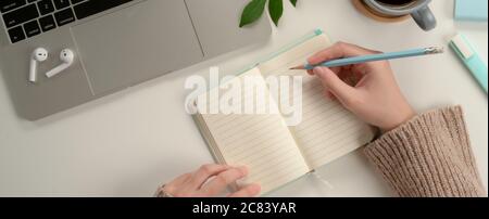 Overhead shot of a study table with notebooks, pencils, coffee and copy ...