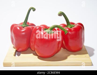 three red paprikas closeup on white background Stock Photo - Alamy
