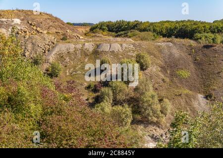 low angle view of a overgrown arid spoil pile at summer time Stock ...
