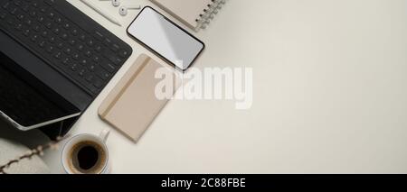 Modern devices with stationery and cup of coffee on color background ...