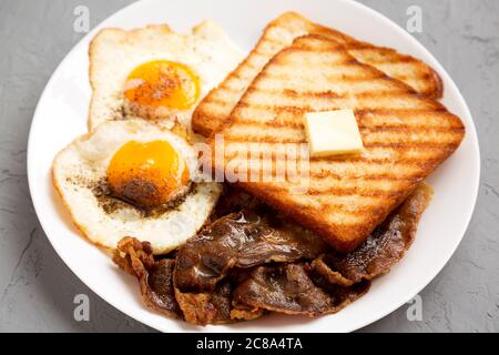 Homemade Healthy Sunnyside Eggs Breakfast on a white plate on a white ...