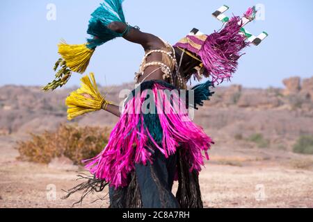 A group of Dogon men performing a ritual tribal masked dance ceremony ...