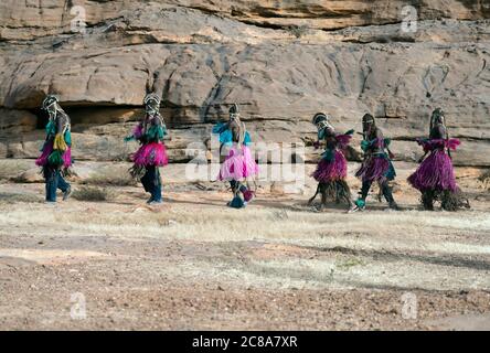 A group of Dogon men performing a ritual tribal masked dance ceremony ...
