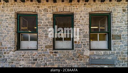 Series of windows lined up on a building of clear stones, mountain ...