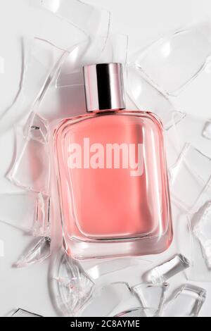 Broken perfume bottle on white background Stock Photo - Alamy