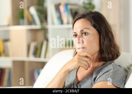 Pensive woman wondering in doubt outside Stock Photo - Alamy