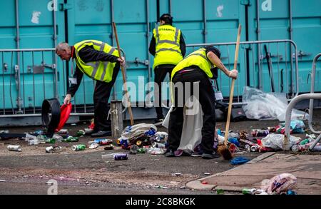 Rubbish is cleaned up outside Anfield following celebrations last night ...