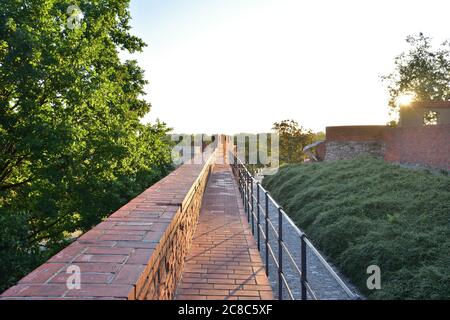 The historic defense walls of the Barbican in Warsaw's Old Town during ...