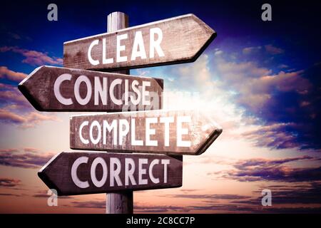 Wooden signpost with clear four arrows Stock Photo - Alamy