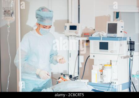 female surgeon in uniform getting ready for medical procedure surgery ...