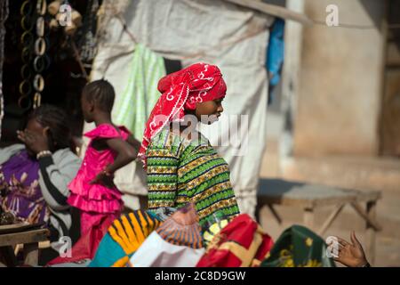 An ethnic Jola tribe woman in colourful traditional clothing at a ...