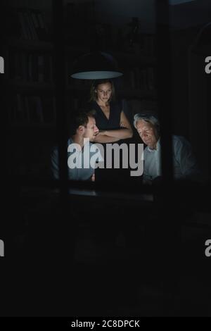 business team with computer working late at office Stock Photo - Alamy