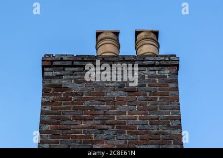 Clay chimney pots on the top of red brick chimney stack of a ...