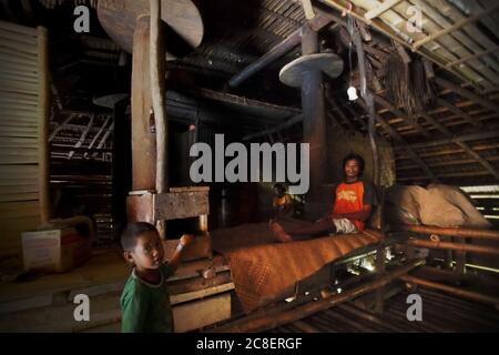 Portrait of a Sumbanese family inside their traditional house in Tebara ...