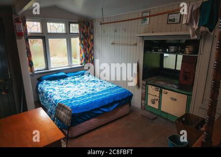 Interior of a small restored bush hut in New Zealand. A classic wood ...