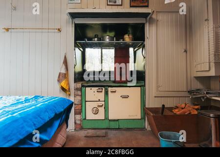 Interior of a small restored bush hut in New Zealand. A classic wood ...