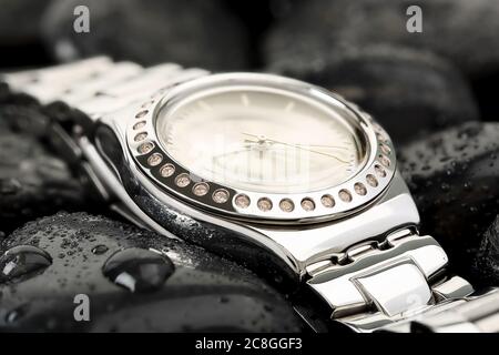 luxurious chrome watch on black stones with waterdrops Stock Photo - Alamy