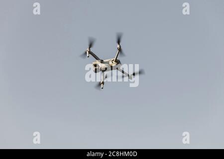 A drone hovering in the grey sky Stock Photo - Alamy