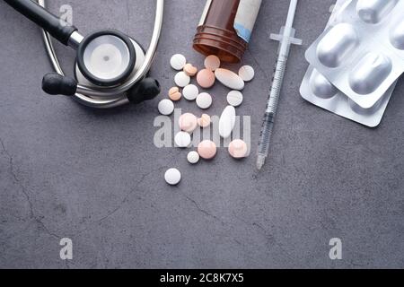 Colorful pills, blister and syringe on a black background Stock Photo ...