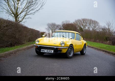 Yellow Triumph GT6 parked on a country lane in Winter Stock Photo - Alamy