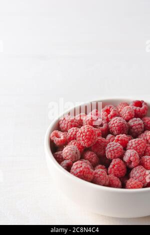 Ripe sweet raspberries in bowls, isolated on white Stock Photo - Alamy