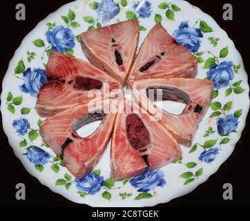 Raw hilsa fish cut into pieces kept on banana leaf for cooking. Shot ...