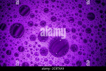 Beautiful shot of soap bubbles on a purple background with interesting ...