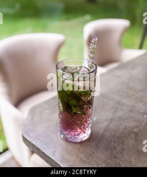 Fresh lavender violet cocktail on black stone concrete background ...