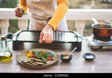 Young woman streaming online healthy food cooking lesson of green salad ...