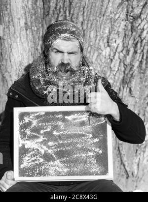 Happy young man with moustache winking and showing thumbs-up ...