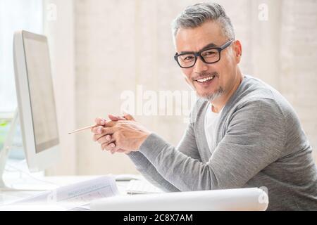 The indoor office senior designer portrait Stock Photo - Alamy
